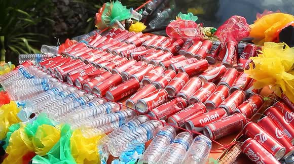 Locals cover their cars in recycled plastic bottles and drinks cans for ...