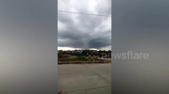 Scary dark funnel cloud swirls over buildings in the Philippines - Buy ...