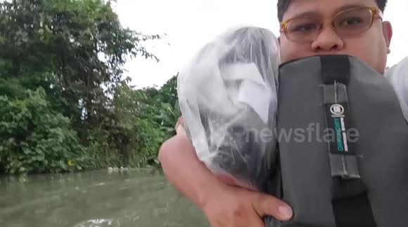 Families escape chest-deep floods swamping villages in the Philippines ...