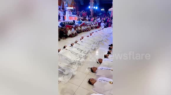 Hundreds of villagers pretend to be corpses during bizarre dance ritual ...