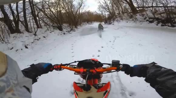 Death-defying escape as two motorbike riders fall through ice during a ...