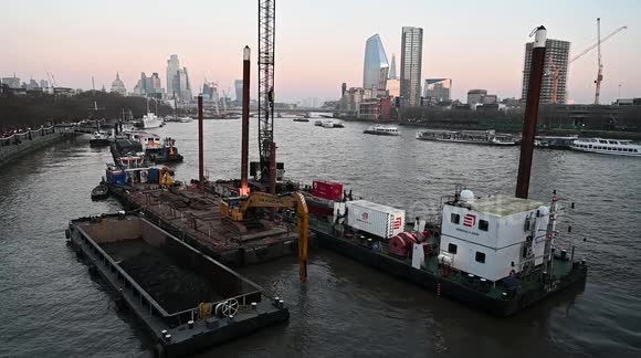 Dredging takes place on the River Thames next to Waterloo Bridge and ...
