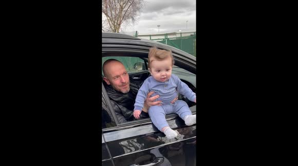 Manchester United manager Erik ten Hag holds baby out of car window ...