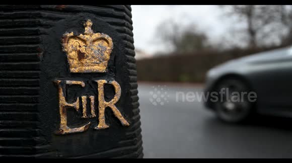 Traffic driving through Regents Parks and the Queens logo, London ...