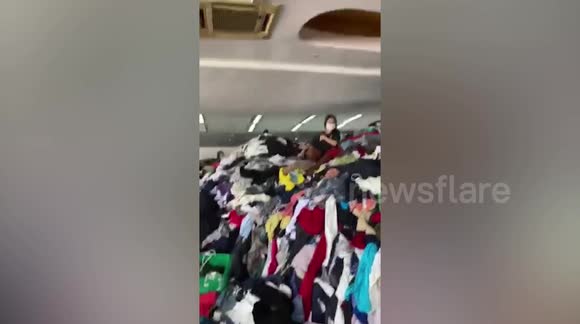 Huge mounds of seconhand clothes clutter warehouse in Thailand - Buy ...