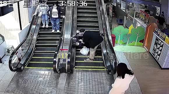 Heroic mall worker saves elderly woman and child from escalator fall in ...