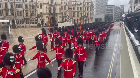 King’s Guards radiate in their bright red uniform in Coronation march ...