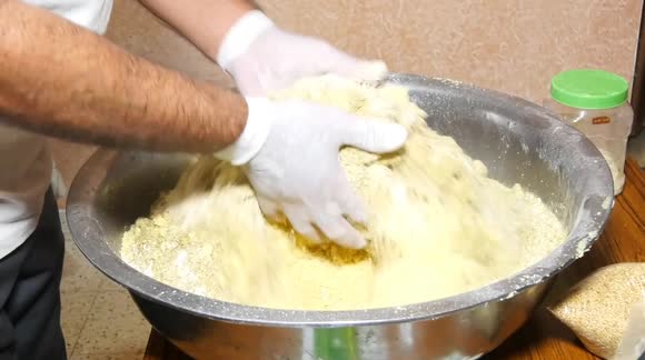 A Palestinian family prepare traditional cookies make traditional date ...