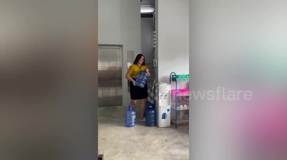 Bungling office worker drops water dispenser jug in amusing workplace ...