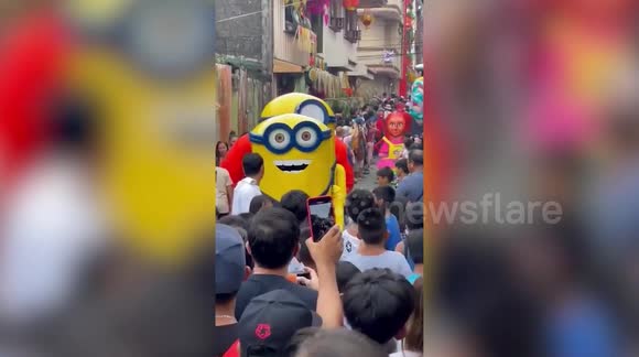 Giant Superman, Batman and Minions mascots join festival parade in the ...