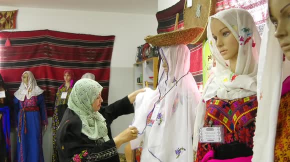 Palestinian woman Laila Shaheen, displays the artifacts and traditional ...