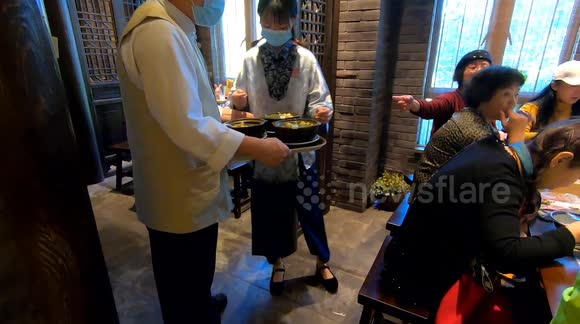 A waiter at a Nanjing food stall in Nanjing, Jiangsu Province serves ...