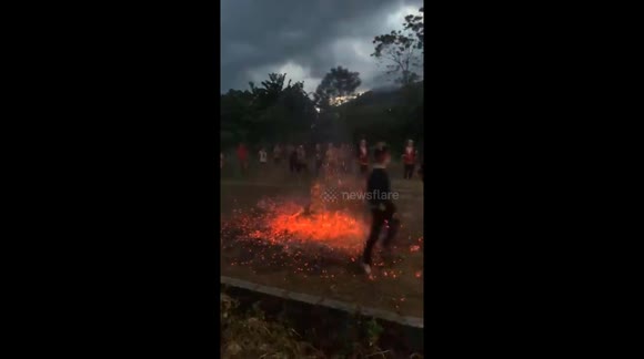 Brave devotees dash barefoot across burning embers during fiery ...