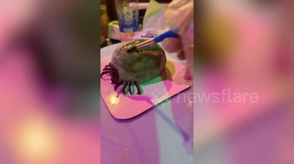 Baker brushes edible paint on giant tick cake - Buy, Sell or Upload ...