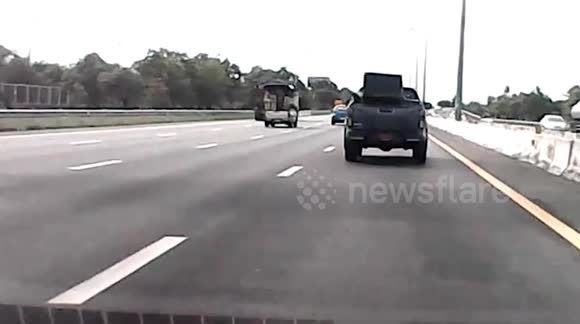 Leather armchairs fly fall from back of pickup truck on Thai motorway ...