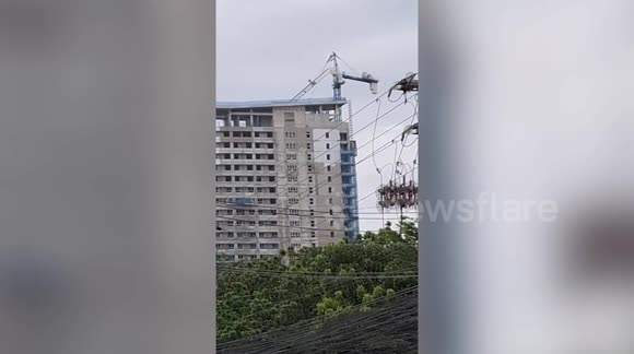 Debris plunges from building as tower crane collapses during ...