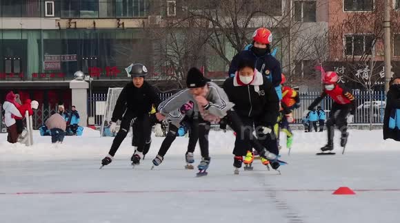 Students enjoy skating on ice-covered ground at school in northeastern ...