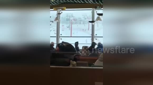 Strong wind shakes ski slope cable cars as tourists cling to seats ...