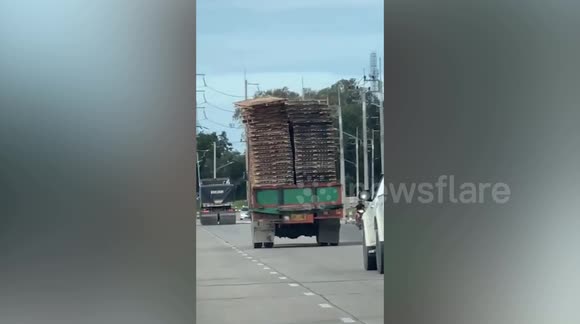 Wooden platform nearly falls from the back of overloaded truck - Buy ...