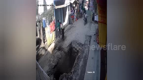 Dramatic footage shows a biker fell into an open pit in the middle of ...