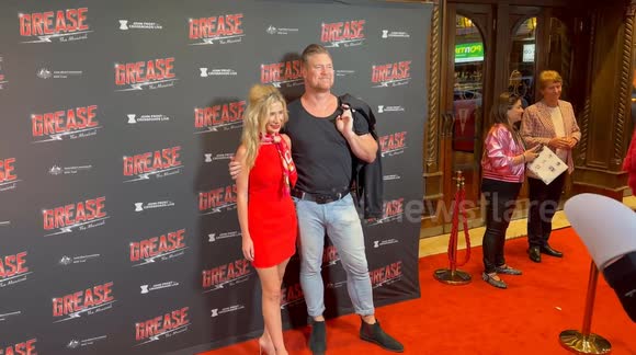 Aimee Woolley and Dean Wells on the red carpet at the Grease opening ...