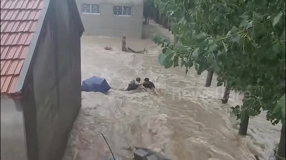 Chinese village official heroically carries trapped elderly woman ...