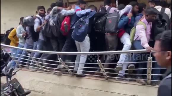 Railing collapses due to massive applicant rush for job openings in ...