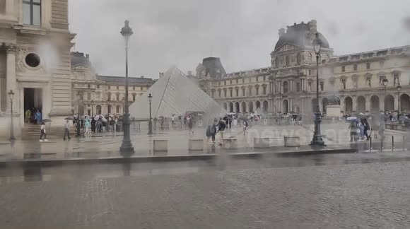 Louvre Museum Pyramide under rain (moving bus view). Paris, France. 17 ...