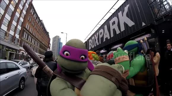 The Teenage Mutant Ninja Turtles meet a drunk man outside of the ...