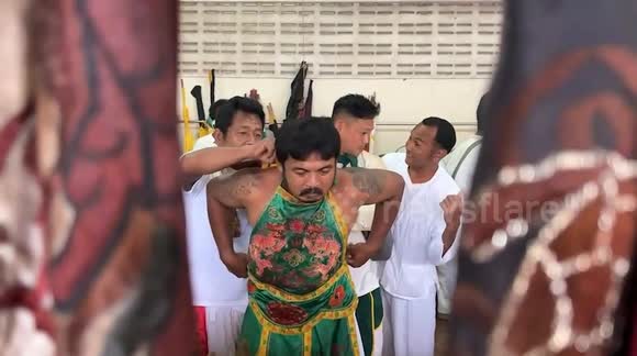 Devotees skewer their cheeks with bizarre items at Vegetarian Festival ...