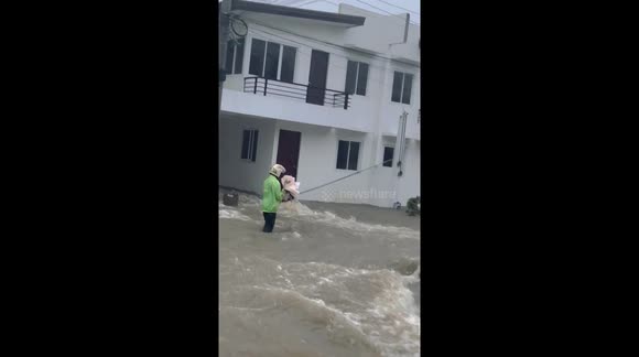 Deliveryman carries flowers through Tropical Storm Trami floods - Buy ...