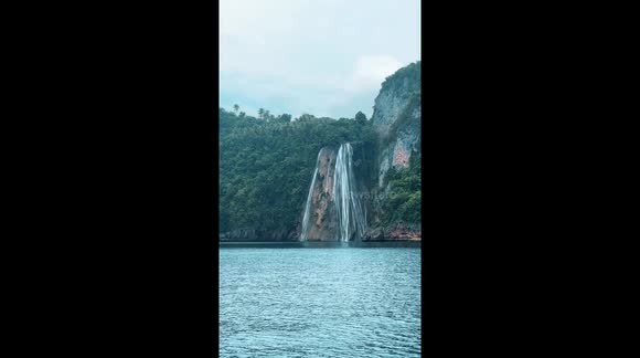 Stunning waterfall flows into the ocean - Buy, Sell or Upload Video ...