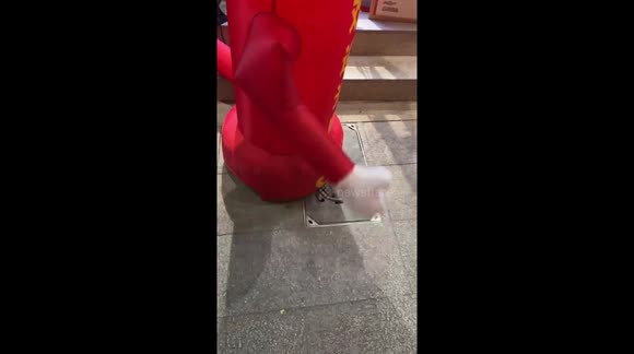Chinese man plays rock paper scissors with inflatable balloon figure ...