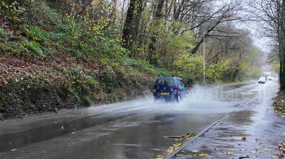 Different Vehicles driving through standing water on the road from ...