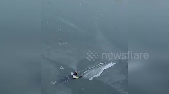 China: Firefighters Crawl Across Ice to Rescue Girl Trapped in Frozen ...