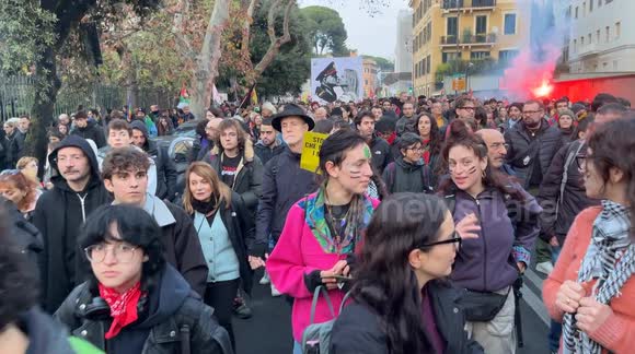 A large sign featuring Giorgia Meloni and Benito Mussolini kissing ...