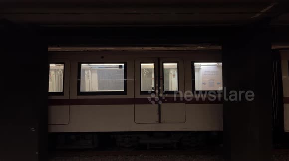 The arrival of a subway train while on the opposite track another empty ...