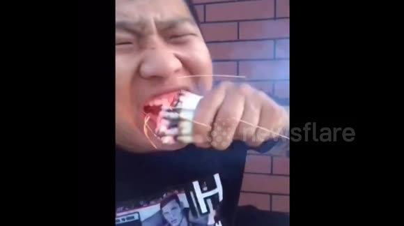 Man eats lit cigarettes - Buy, Sell or Upload Video Content with Newsflare