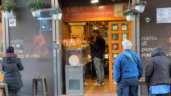 A big mortadella attracts customers to a bakery that sells white pizza ...