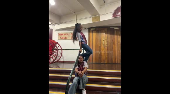 Woman loses balance while sitting on stair handrail in Johannesburg ...