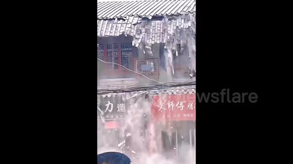 Strong winds rip tiles off building roof seeing them cascade like snow ...