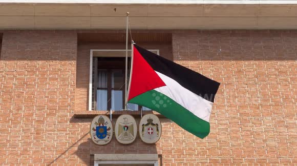 The Palestinian flag flies at half-mast from the window of the Embassy ...