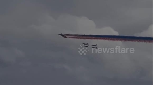 The Red Arrows perform a London flyby in front of a dramatic stormy sky ...