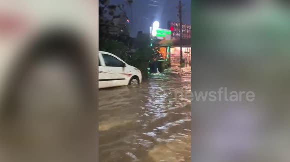 Fierce rainstorms lead to knee-deep flooding turning city roads into ...