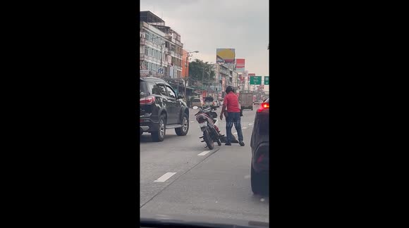 Motorcycle rider helps monitor lizard to cross a road in Thailand - Buy ...