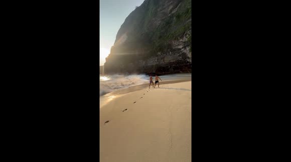 Tourists knocked over by wave crashing onto beach in Bali - Buy, Sell ...