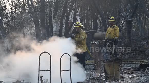 Fire extinguishing efforts continue as wildfire destroys buildings in ...