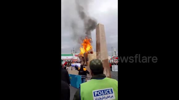 Iran: Iranian protesters burn a statue with the inscription "Baal ...