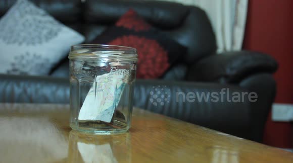 Dropping change into a jar - Buy, Sell or Upload Video Content with ...