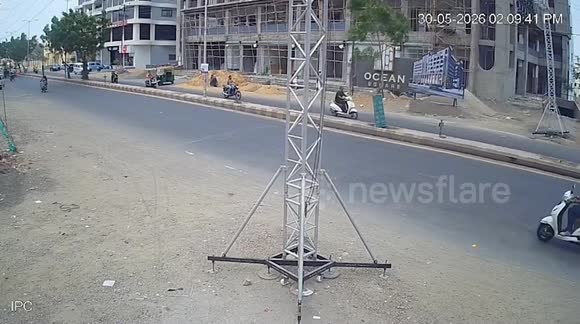 Motorcycle riders narrowly avoid gantry billboard as it crashes onto ...